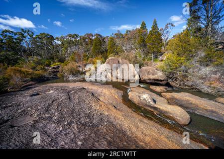 Water cascading over granite rock bed, Bald Rock Creek, Girraween ...