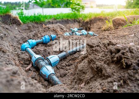 Plastic pipes and circuit wiring for lawn irrigation. Connection ...