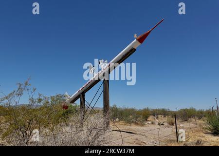A roadway sign for the town of Wikieup, Arizona of a rocket with Snoopy ...