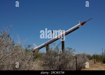 A roadway sign for the town of Wikieup, Arizona of a rocket with Snoopy ...