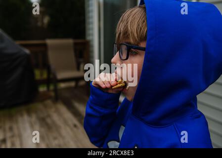 Boy eating S'more with marshmallow and glasses Stock Photo - Alamy