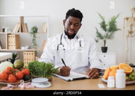 Doctor gastroenterologist filling patient's case history and ...