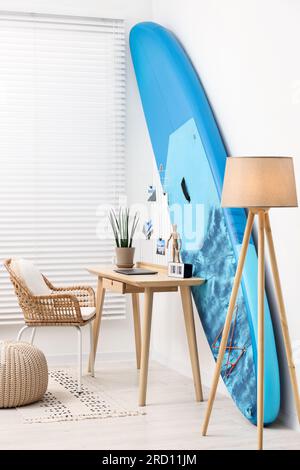 SUP board and workplace in room. Interior design Stock Photo - Alamy