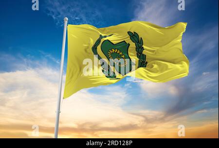 official flag of Perlis Malaysia at cloudy sky background on sunset ...