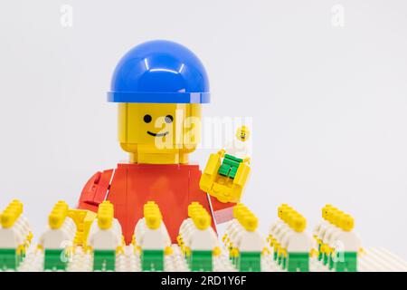Giant man pick up the small one in the crowded people Stock Photo - Alamy