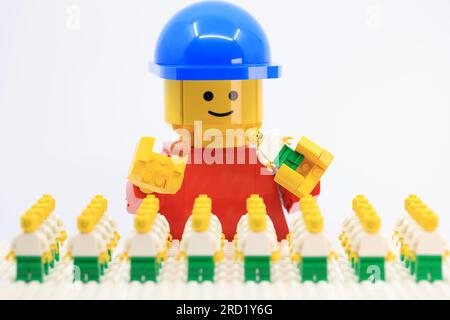 Giant man pick up the small one in the crowded people Stock Photo - Alamy