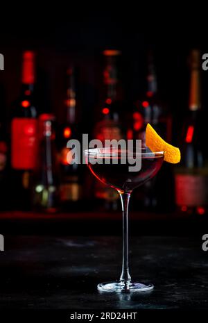 Adonis alcoholic cocktail drink with sherry and red vermouth, black bar ...