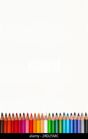 Crayons in line on a blank sheet of paper Stock Photo - Alamy