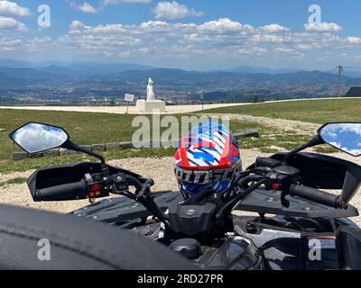 Ready for Action: Blue and Red Helmet on ATV Quad backside view Stock ...