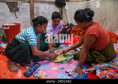 Imphal, India. 15th July, 2023. A Meitei woman demonstrates a candle ...