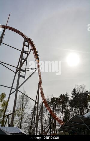 Roller coaster with full carriages in the amusement park with sun Stock ...
