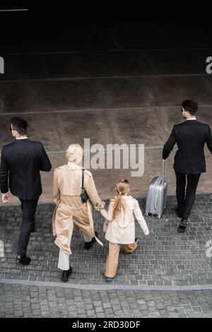 personal safety, professional bodyguards walking next to woman and ...