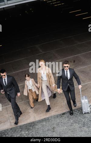 personal safety, professional bodyguards walking next to woman and ...