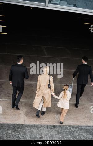 bodyguards protecting privacy of female clients, woman and her daughter ...