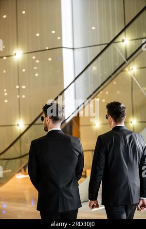 security management of luxury hotel, two handsome men in formal wear ...