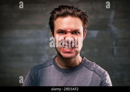 Angry man with sneer on his face Stock Photo - Alamy
