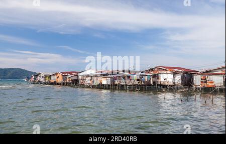 Colorful coastal wooden houses and barns on stilts in poor district of ...