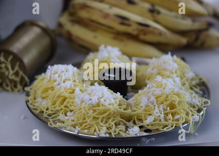 Ethakka idiyappam served inside the idly mould. String hoppers or ...