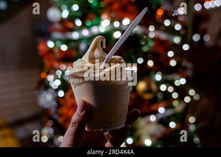 Dole Whip pineapple soft serve in a person's hand at the Hello Kitty Cafe, Santa Clara ...