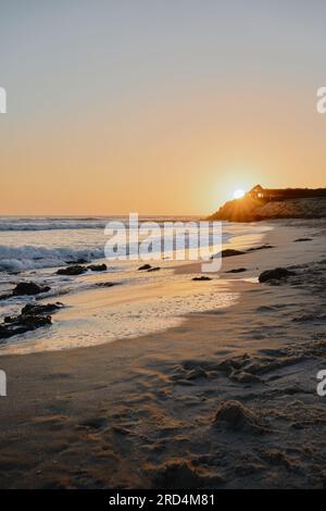 sunset on the beach with nice colors and reflection Stock Photo - Alamy