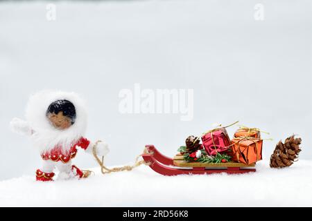 Christmas decoration, Inuit pulling sleigh with Christmas presents ...