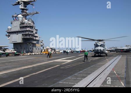 A French Navy NH90 NATO frigate helicopter approaches the flight deck of the world’s largest ...