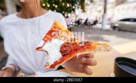 Woman's hand holding a pizza outdoor Stock Photo - Alamy