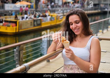 Tourist eating mitarashi dango at street Stock Photo - Alamy