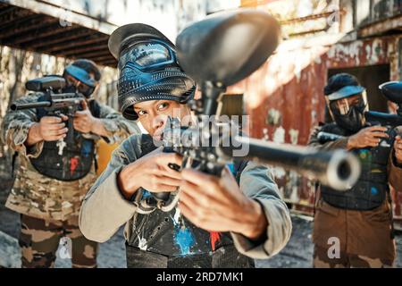 Paintball team, gun and woman aim, focus and shooting at target ...