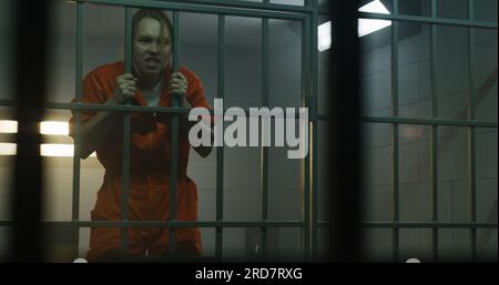 Insane female prisoner in orange uniform yells at neighbor inmate ...