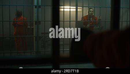 Insane female prisoner in orange uniform yells at neighbor inmate ...