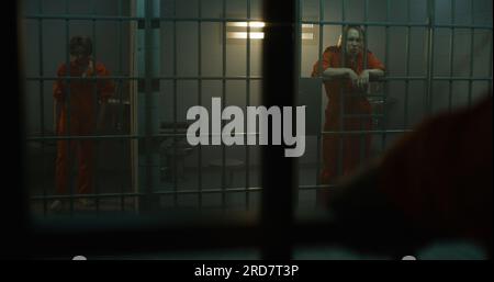 Insane female prisoner in orange uniform yells at neighbor inmate ...