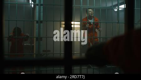 Insane female prisoner in orange uniform yells at neighbor inmate ...