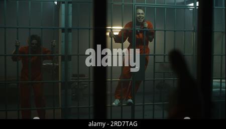 Aggressive female prisoner in orange uniform yells at neighbor inmate ...