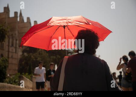 Palma, Spain. 19th July, 2023. July 19, 2023, Palma: People with a fan ...