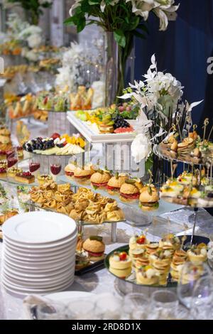 various snacks and drinks at the buffet table at the corporate catering ...