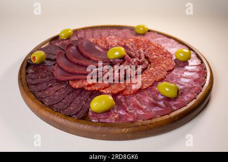 cold cuts of sausage delicacies on a wooden round stand Stock Photo - Alamy