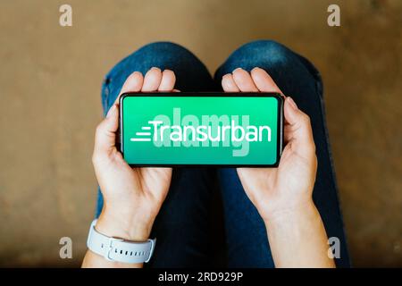 In this photo illustration, the Transurban logo is seen displayed on a ...
