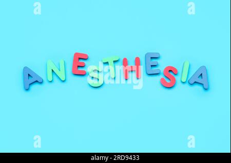 Flat lay composition with word Anesthesia and drugs on light blue ...