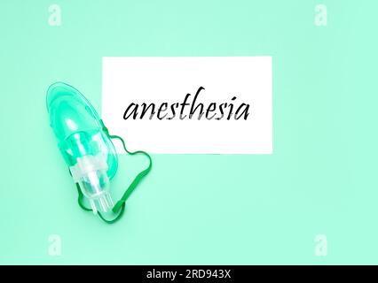 Paper with word ANESTHESIA and oxygen mask on green background Stock ...