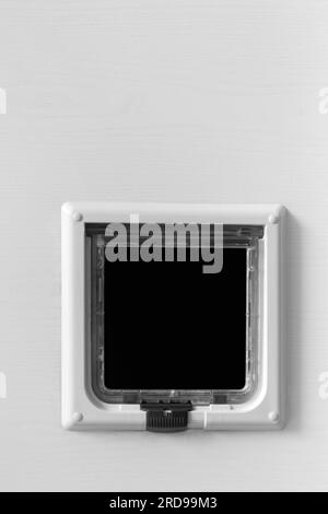 Pet door, cat hatch, a flap is built into the door of the apartment for ...
