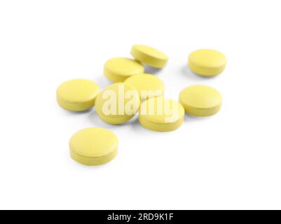 Many yellow pills isolated on white. Medicinal treatment Stock Photo ...