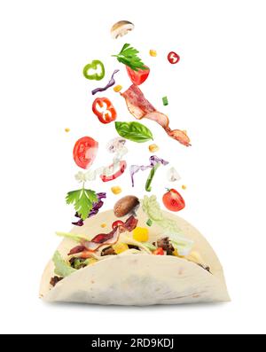 Mexican taco with falling beef meat and vegetables isolated on white ...