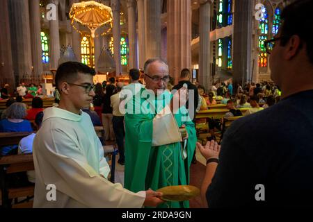A priest giving the Holy Communion to the faithful Stock Photo - Alamy