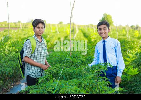 Indian school kids working in farm, happy farmer Stock Photo - Alamy