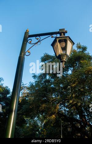 Retro rusty street lamp post on brick wall background Stock Photo - Alamy