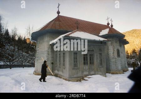 An orthodox monk playing the semantron around Visoki Dečani church ...