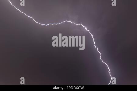 Picture of a flash in the night sky with glowing clouds in summer Stock ...