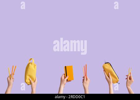 Hands with school supplies on lilac background Stock Photo - Alamy