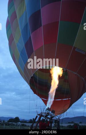 Inflation process and preparation of hot air balloon at sunrise to fly ...